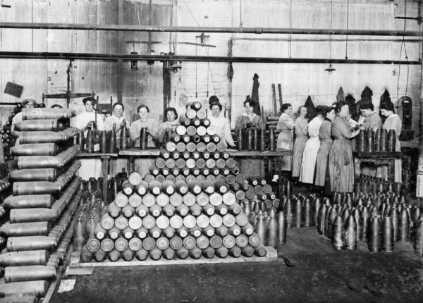 Female munitions workers put the finishing touches to high explosive ...